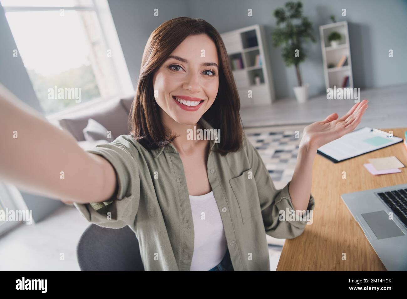 Photo of attractive positive person sitting chair make selfie recording ...