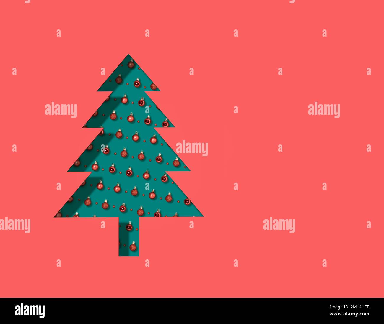 A creative green Christmas tree on a bright red background with copy ...