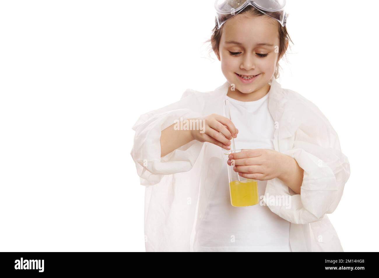 Details: child's hands mixing yellow liquid chemical in a beaker, with ...