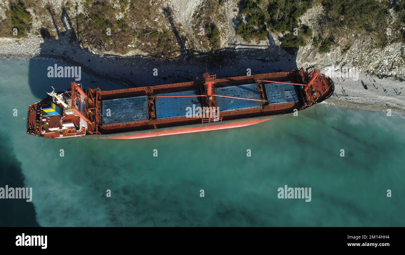 Aerial top view of an empty, red barge moored near the beautiful blue ...