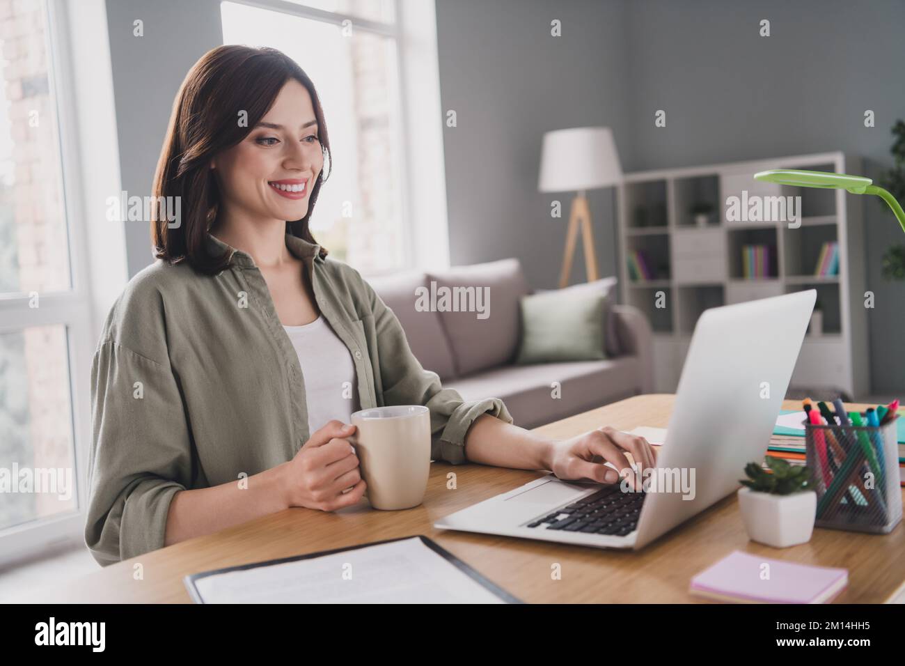 Photo of pretty positive person sitting chair arm hold fresh cacao mug ...