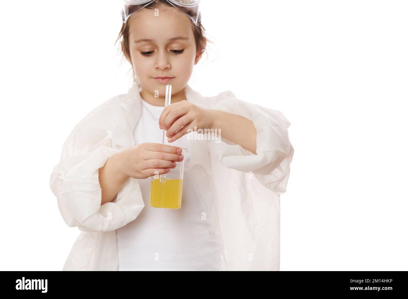 Details: Hands of child chemist scientist mixing yellow liquid chemical ...