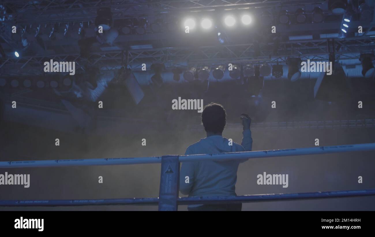 Back view of working gaffer or lighting technician and spotlights ...