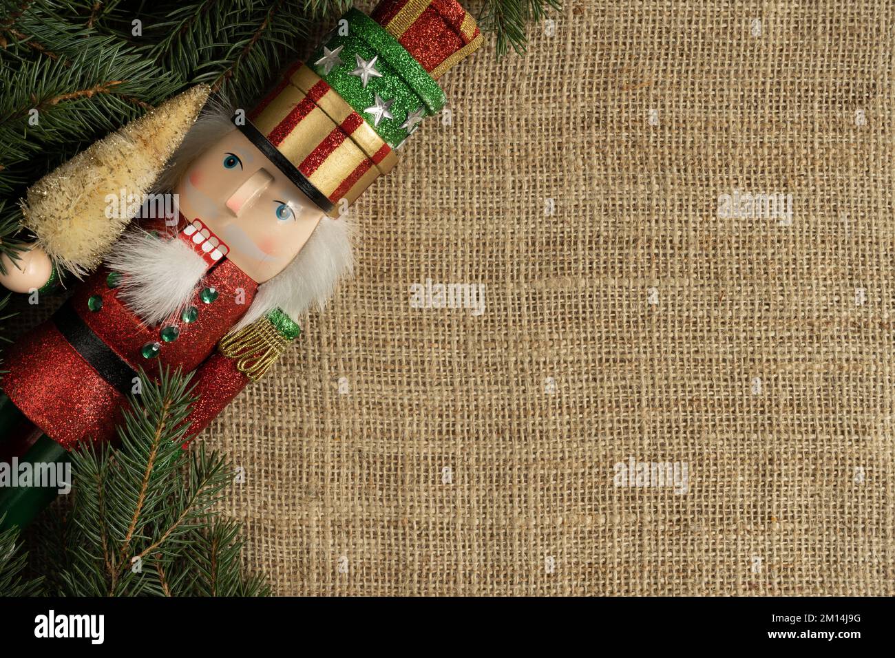 Christmas nutcracker wooden figure and tree branches. Festive toy ...