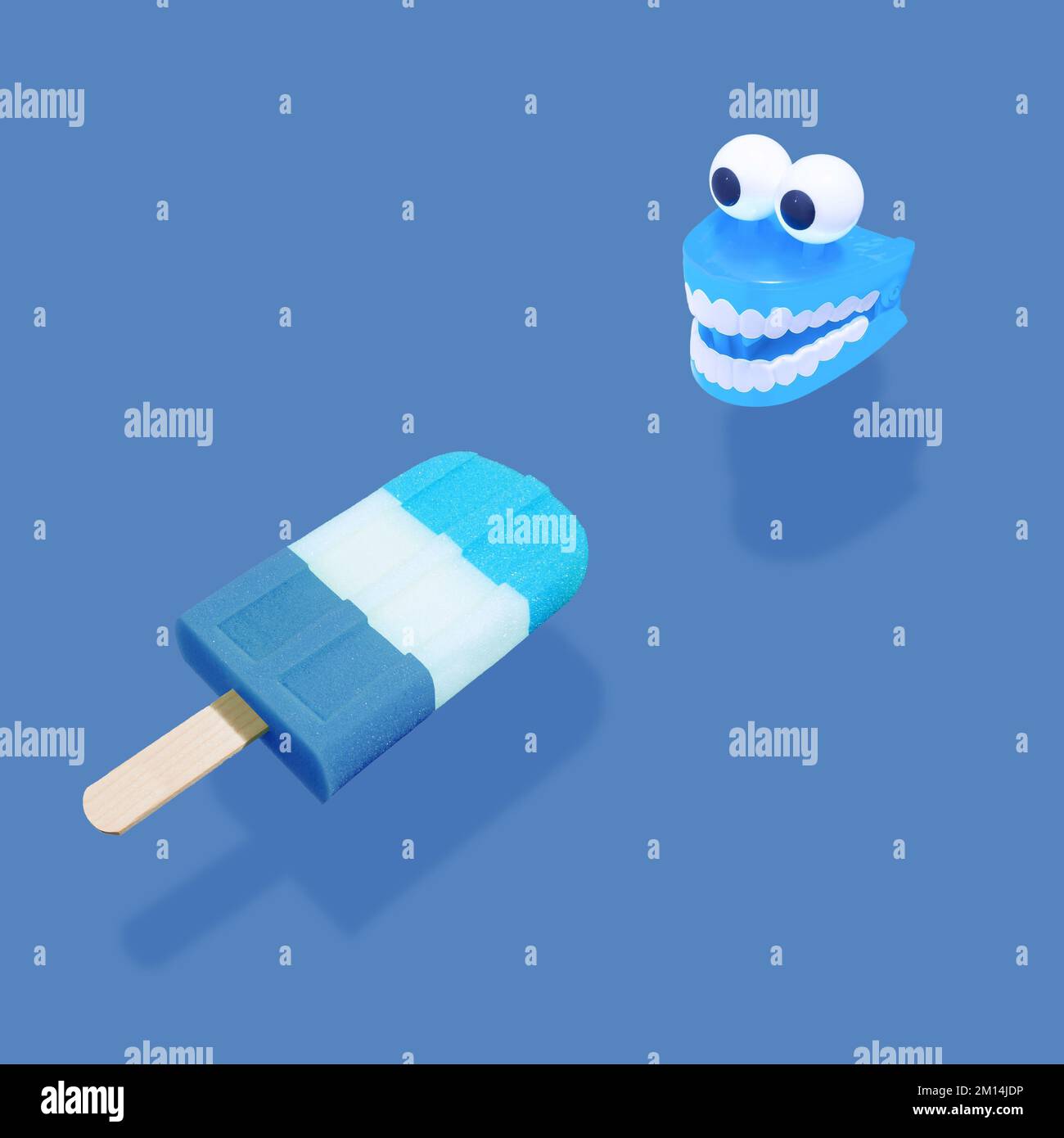 A 3D of blue popsicle ice cream and plastic toy teeth against blue ...