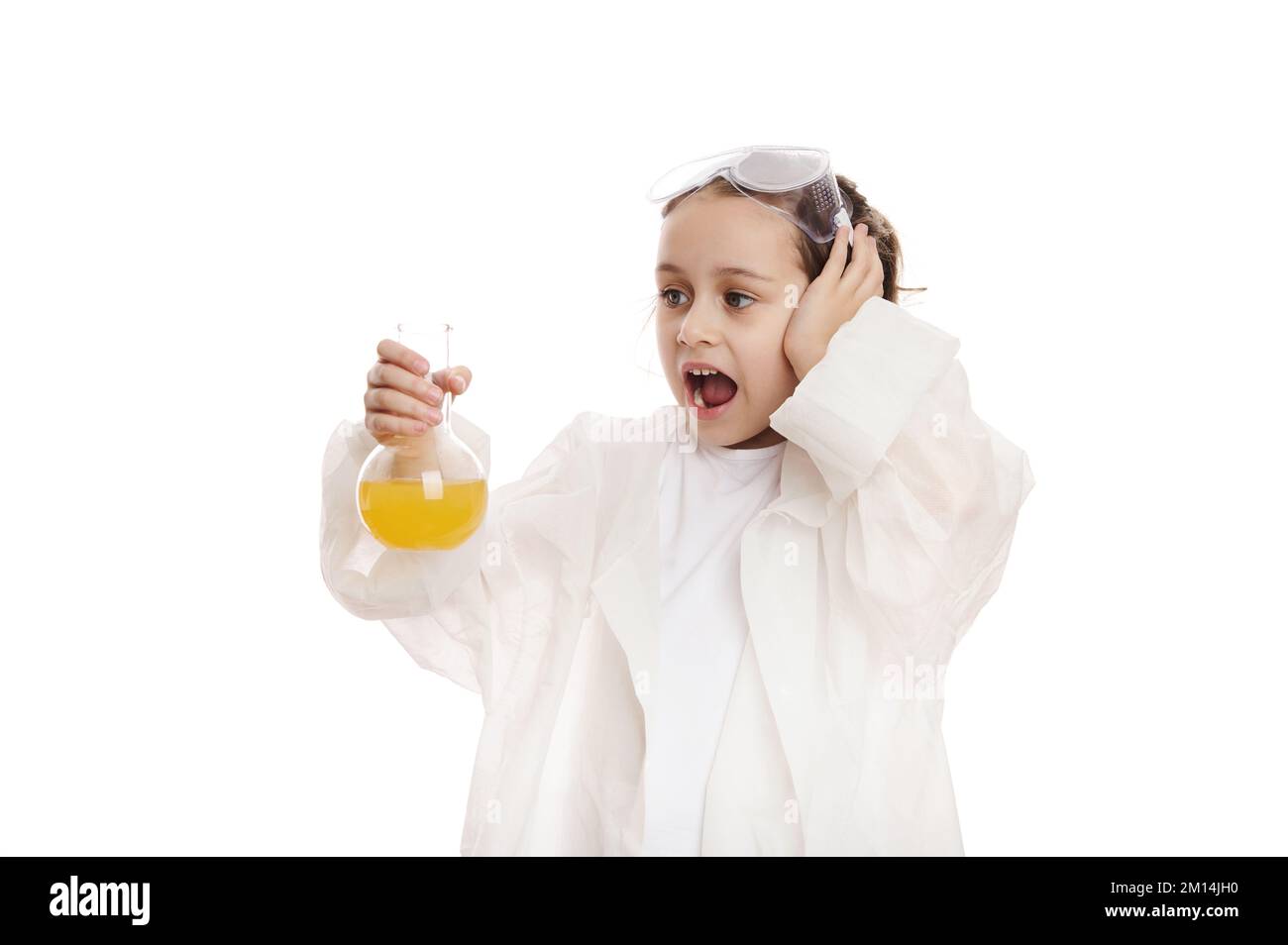 Smart schoolgirl at chemistry class, surprised by chemical reaction ...