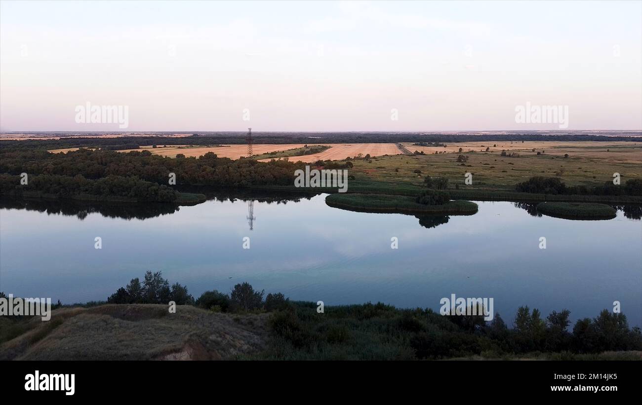 Aerial view of river curving along farmlands. Stunning panoramic aerial ...