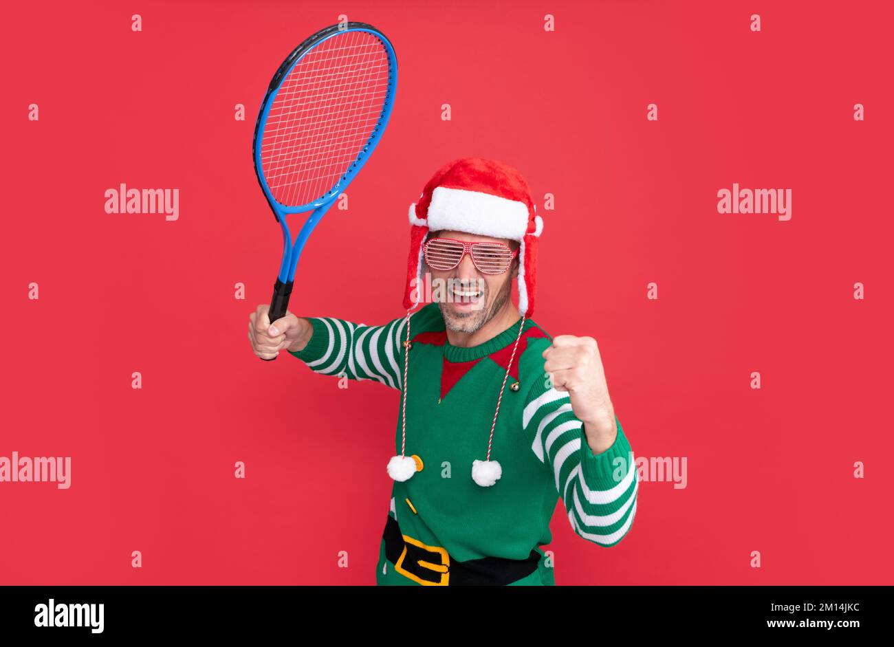 happy successful man in elf costume and santa claus hat. xmas guy hold ...