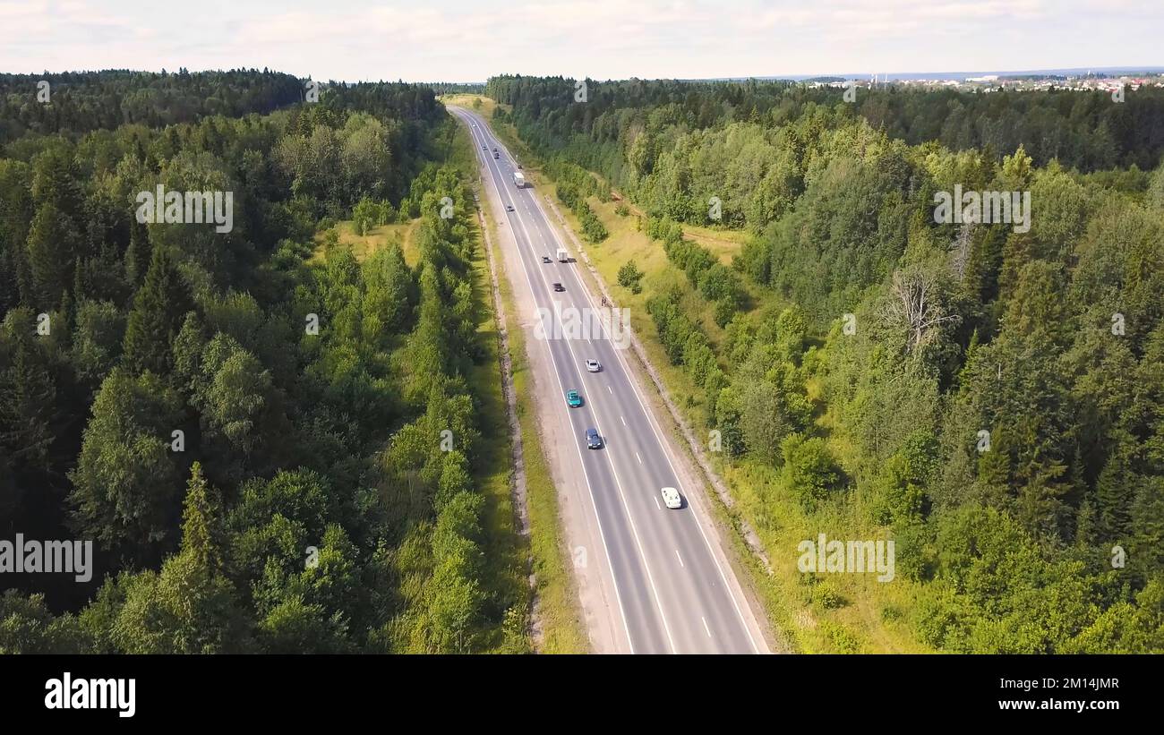 Aerial view of car driving through the forest on country road. Cars ...