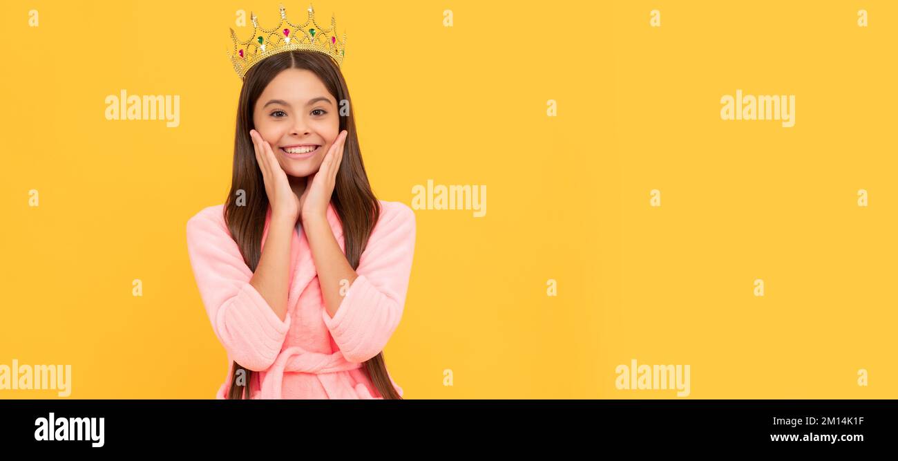 smug happy teen girl in home terry bathrobe and princess crown ...