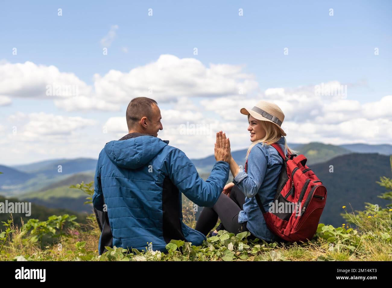 Portrait of beautiful young couple enjoying nature at mountain peak Stock Photo - Alamy