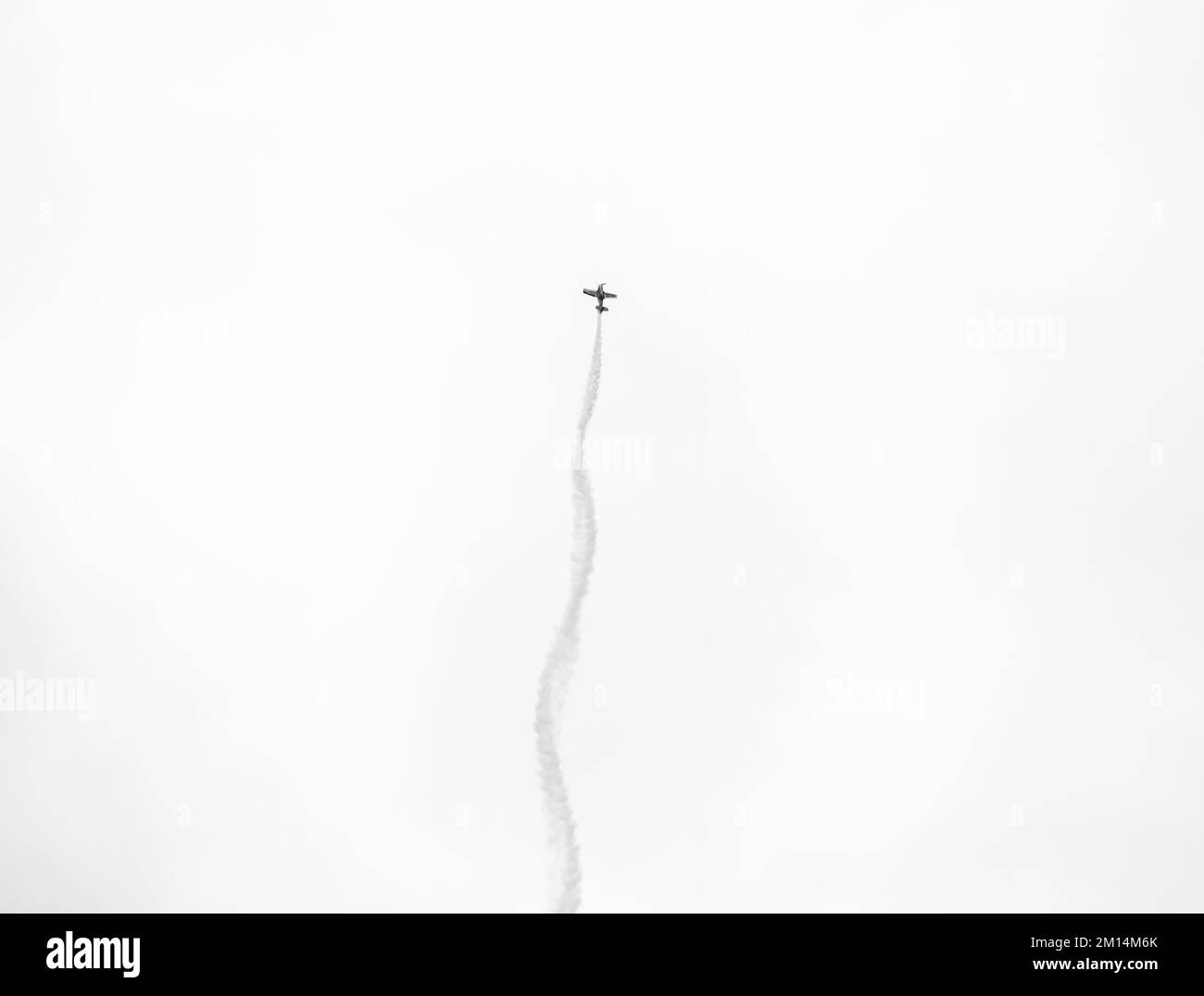 Minimalist picture with an acrobatic aircraft light airplane leaving ...