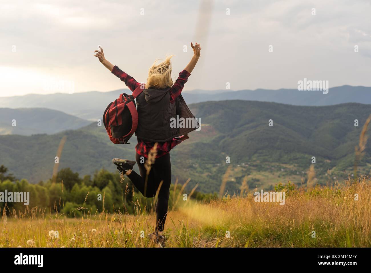 Girl Traveler hiking with backpack at rocky mountains landscape Travel ...