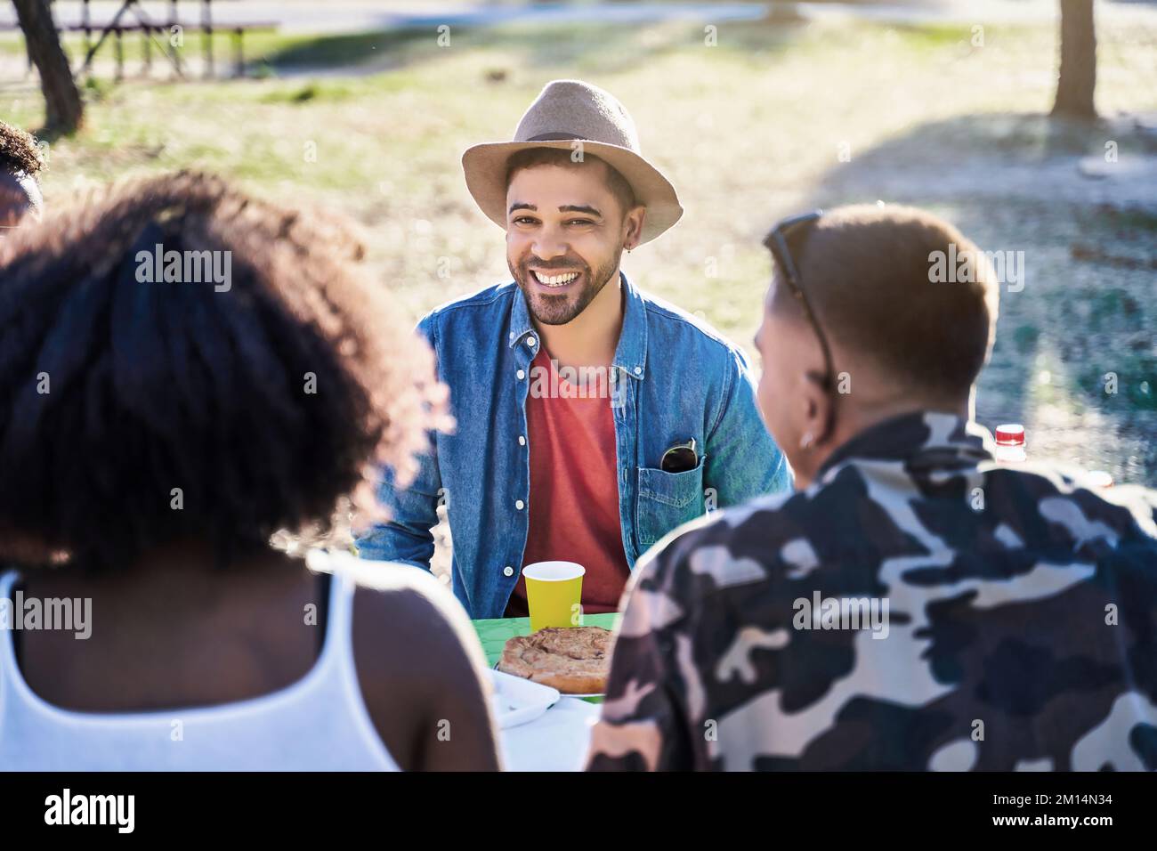 Young man sitting picnic table hi-res stock photography and images - Alamy