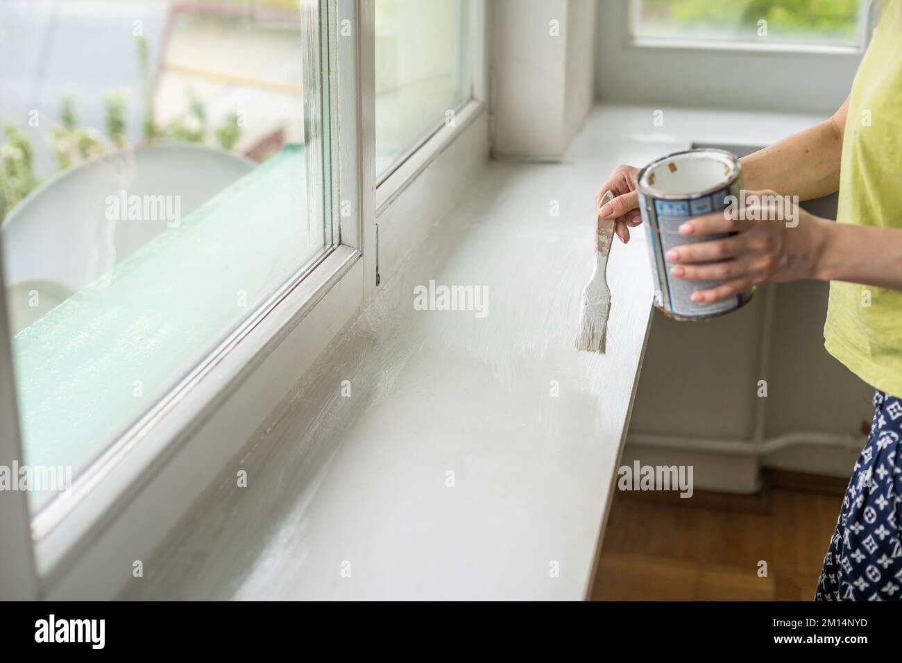 hand painting the window frame Stock Photo - Alamy