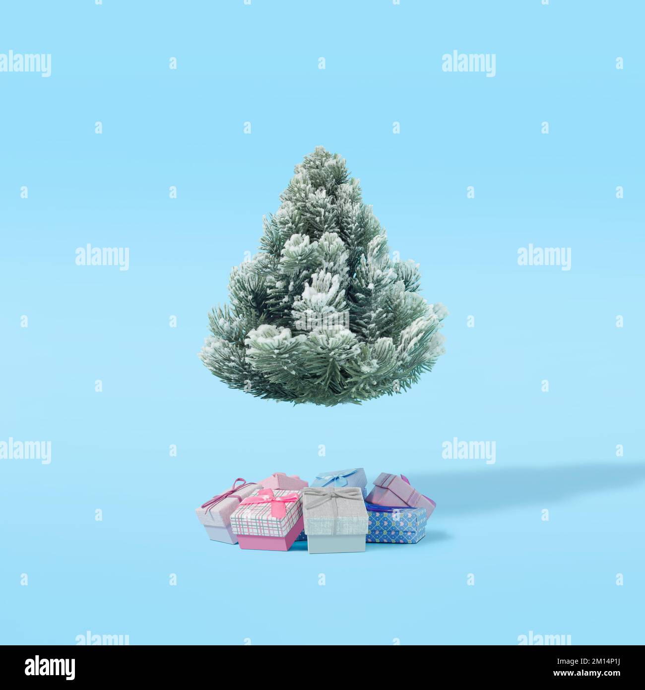 A Christmas tree with gift boxes on bright blue background Stock Photo ...