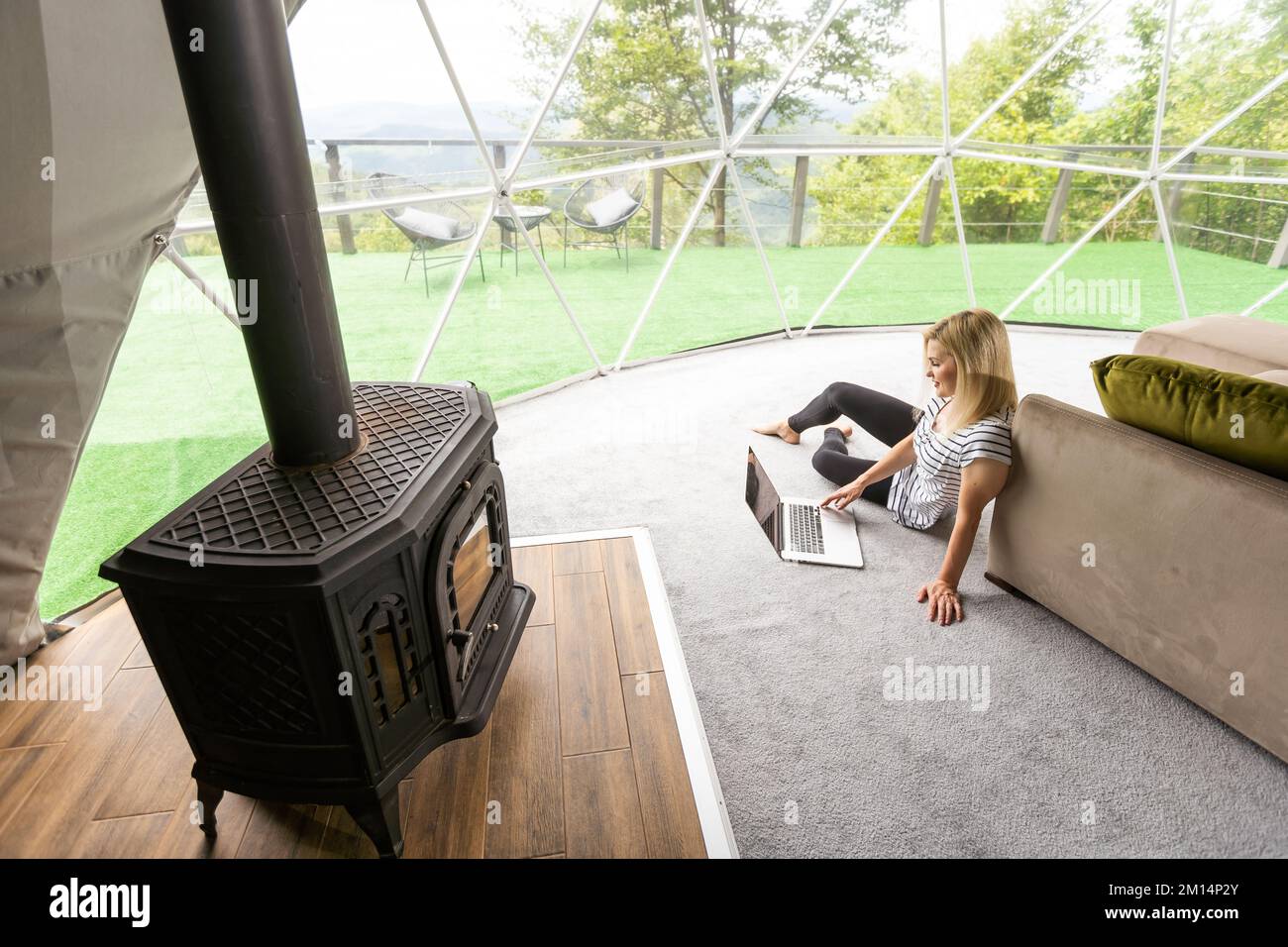 Young caucasian woman using and watching on laptop computer on in dome ...