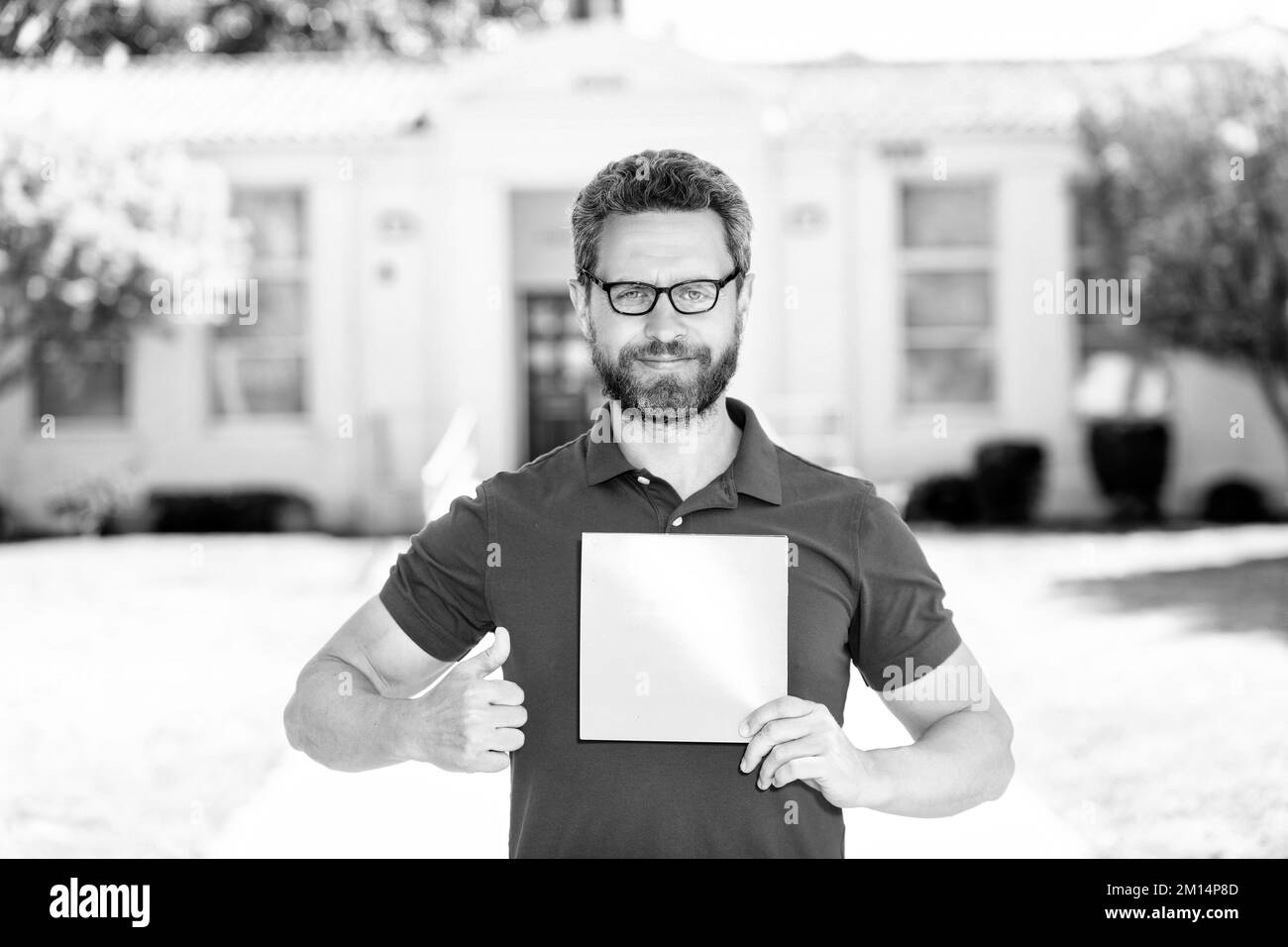 cheerful man in eyeglasses showing paper. thumb up. vision acuity ...
