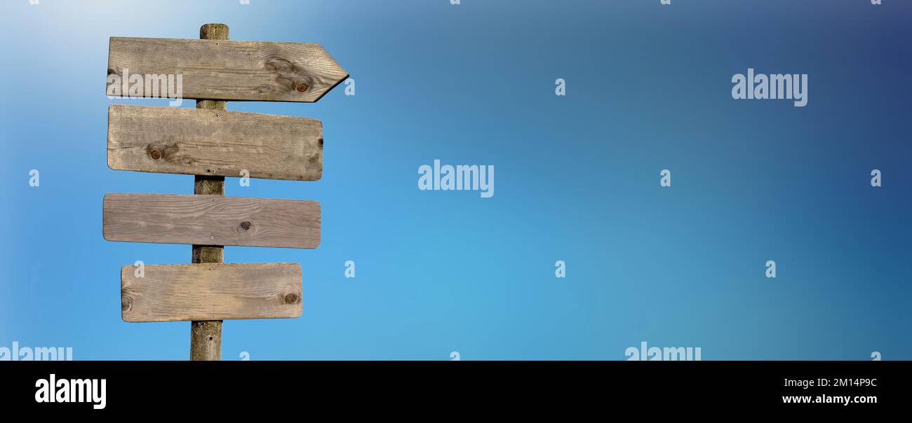 wooden directional post with arrow pointing right on blue sky ...