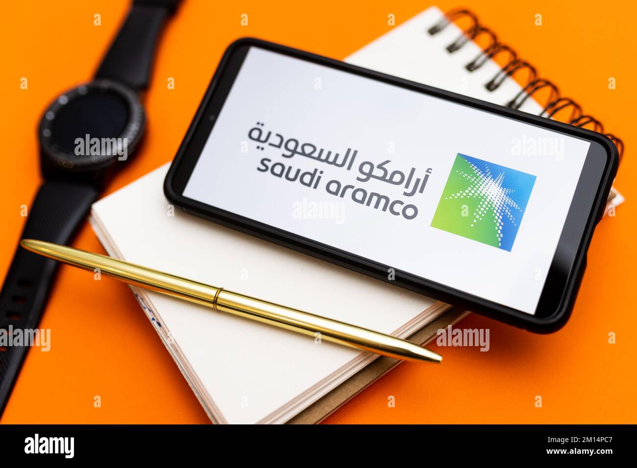 In this photo illustration a Saudi Aramco logo seen displayed on a ...