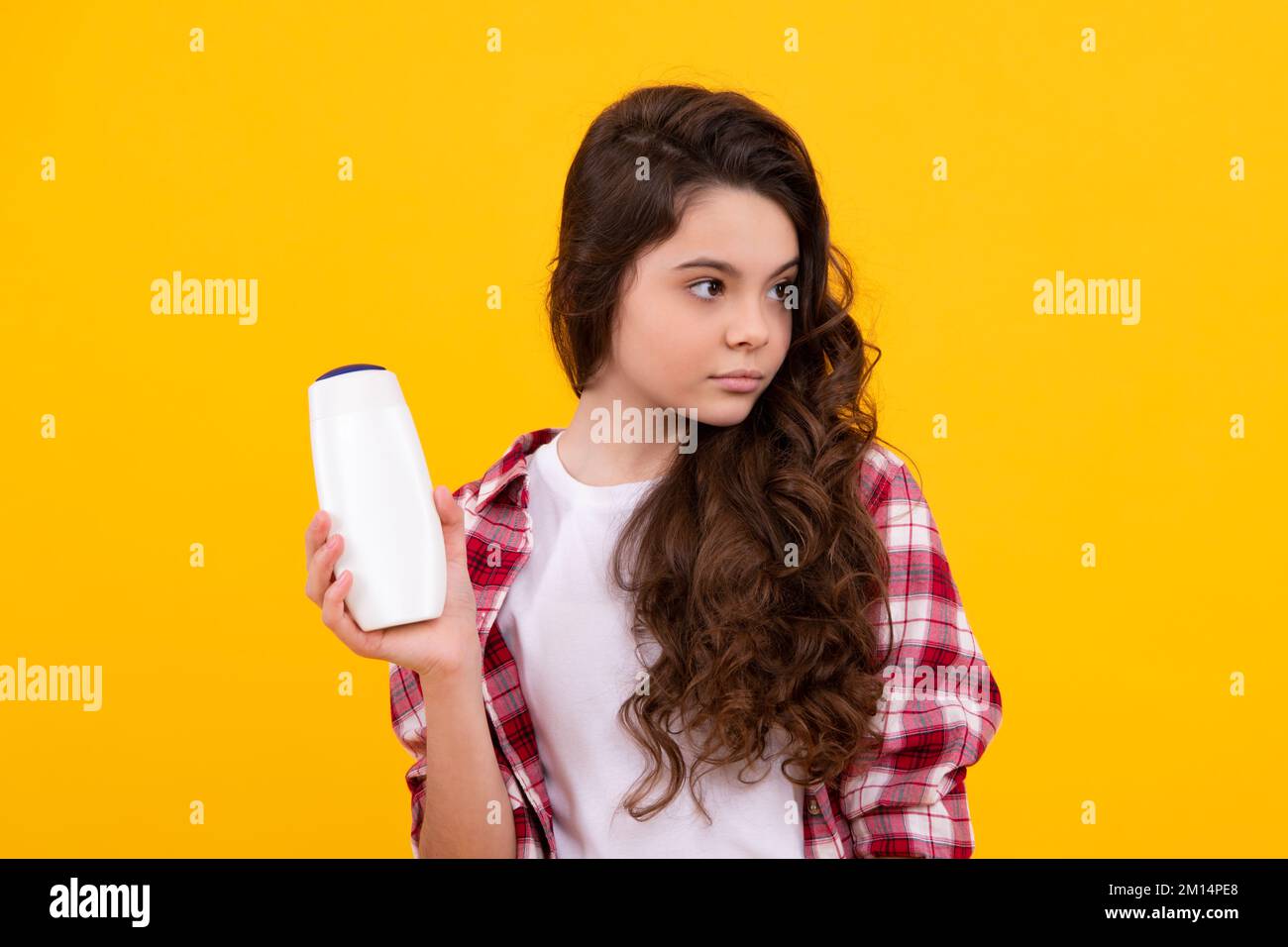 Child teen girl with shampoos conditioners and shower gel. Long hair ...
