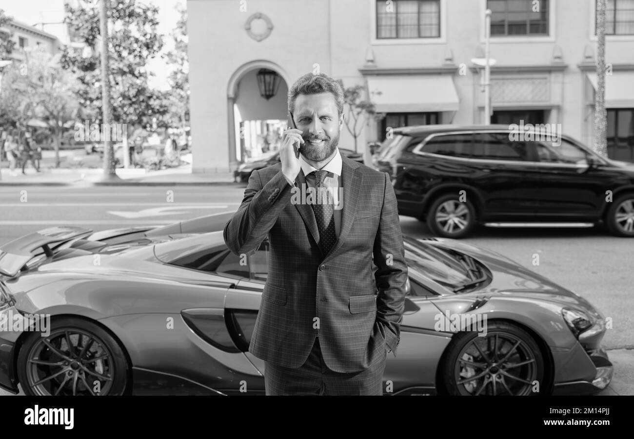 salesman speaking on mobile phone. rich guy rent car Stock Photo - Alamy salesman speaking on mobile phone. rich guy rent car Stock Photo - Alamy