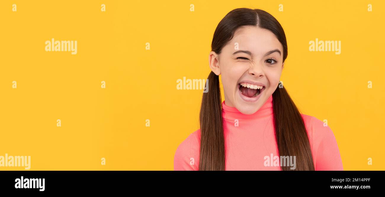 pretty look of young teen girl on yellow background. portrait of happy ...