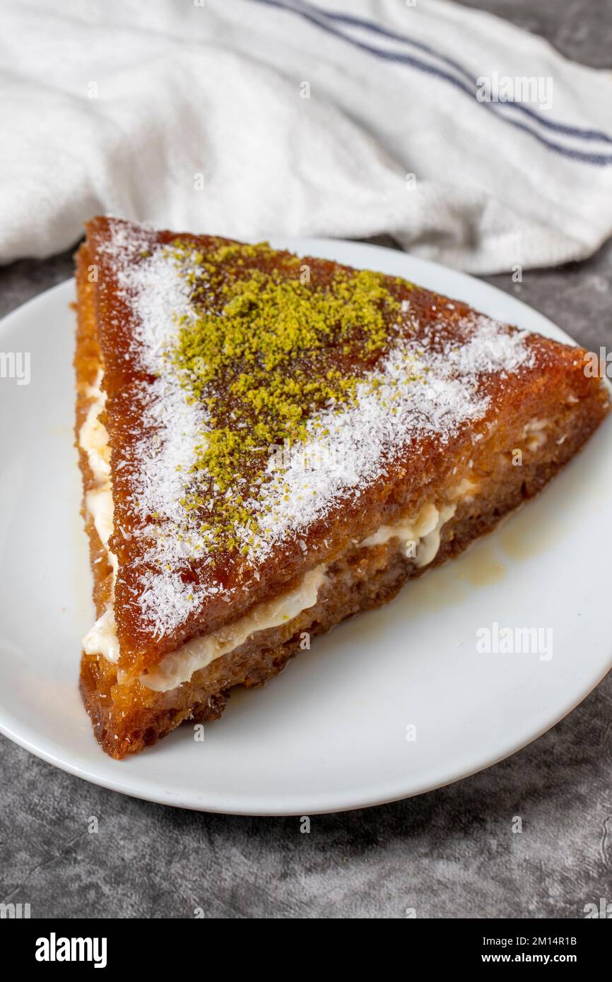 Bread kadayif dessert with cream on a dark background. Turkish cuisine ...
