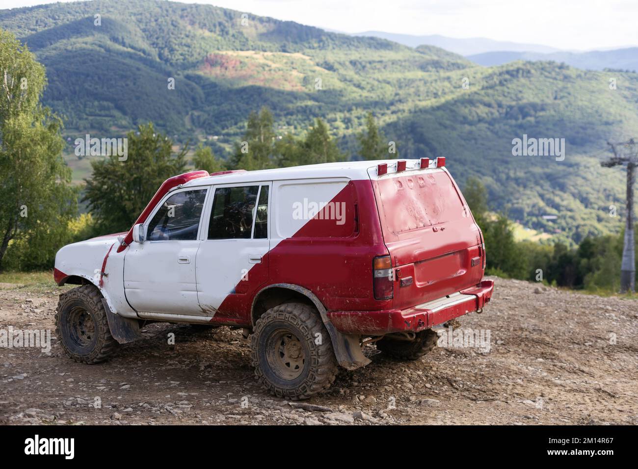 Old four-wheel drive vehicles driving on rocky mountain road on ...