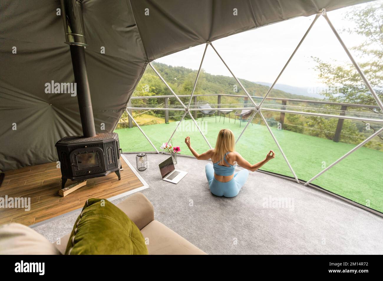 A woman is in a geo dome glamping tent. Glamping vacation lifestyle ...