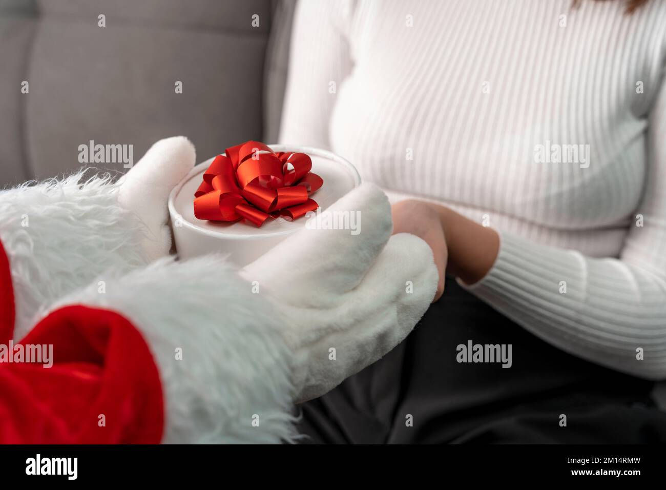 Santa gives a Christmas gift to a girl Stock Photo - Alamy