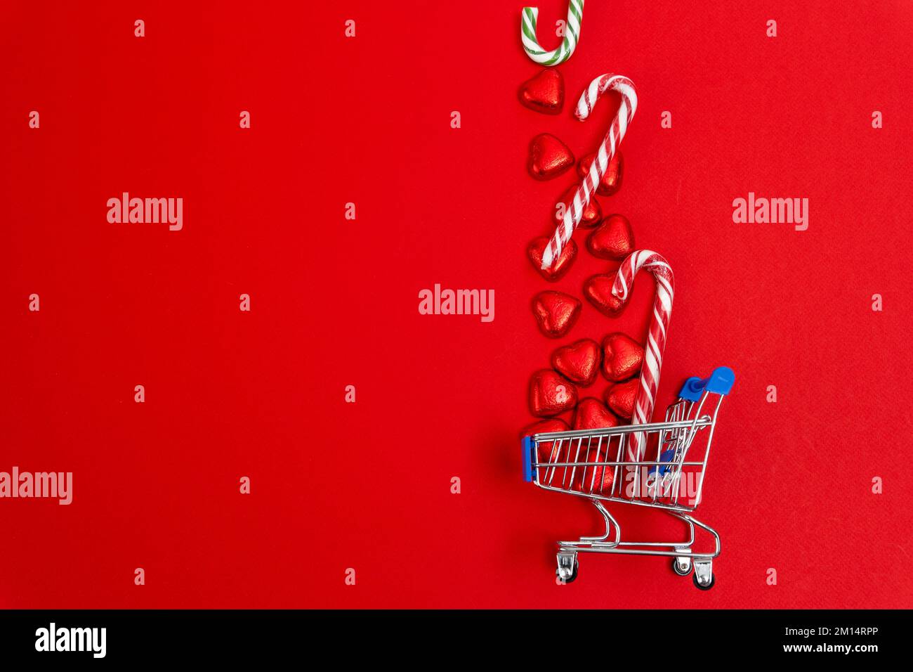 red festive Christmas background with a supermarket cart Stock Photo ...