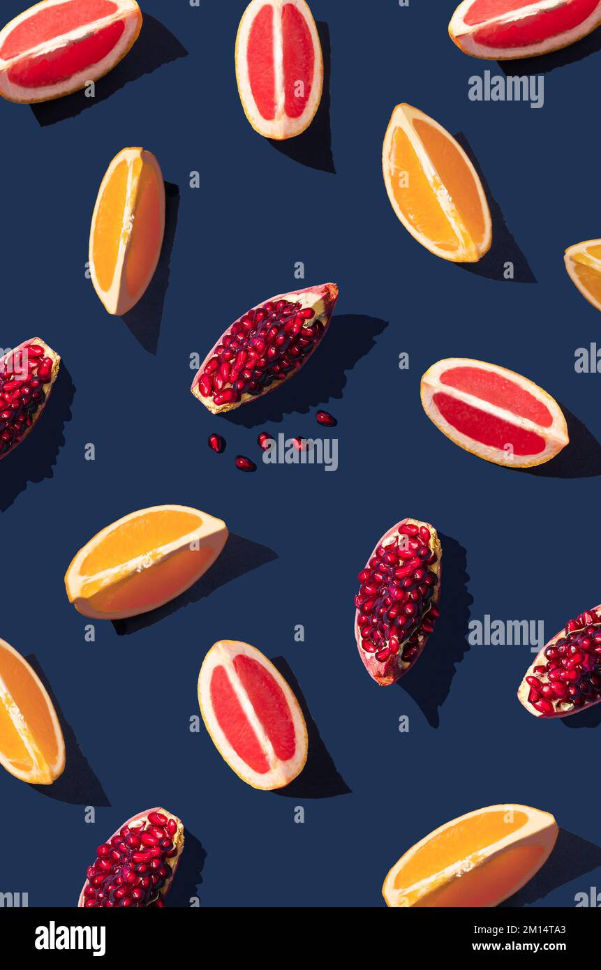 A vertical 3D rendered slices of summer citrus fruits on a blue ...