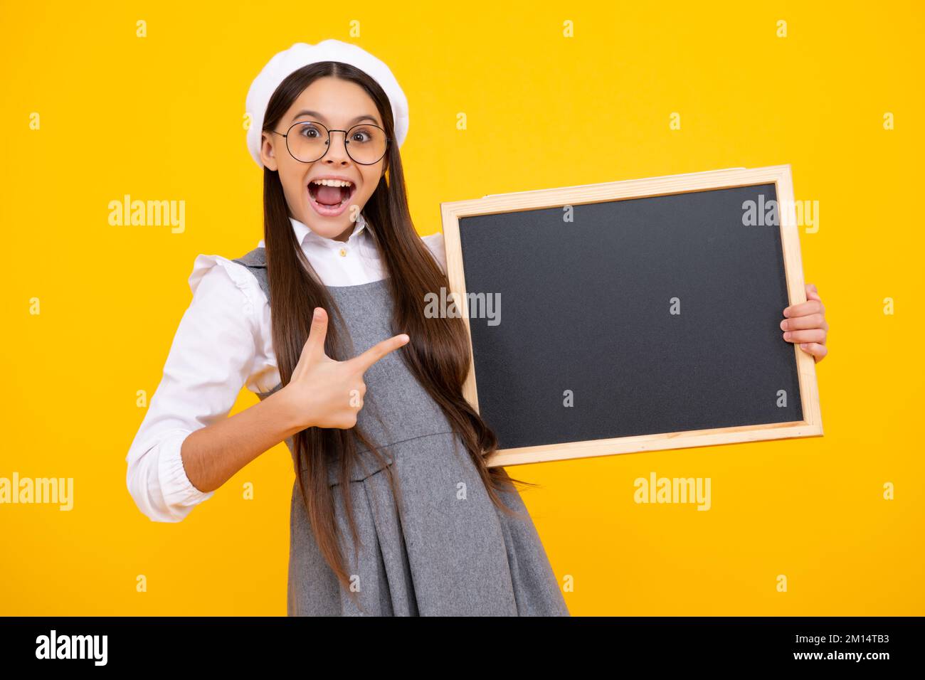 Teenager younf school girl holding school empty blackboard isolated on ...