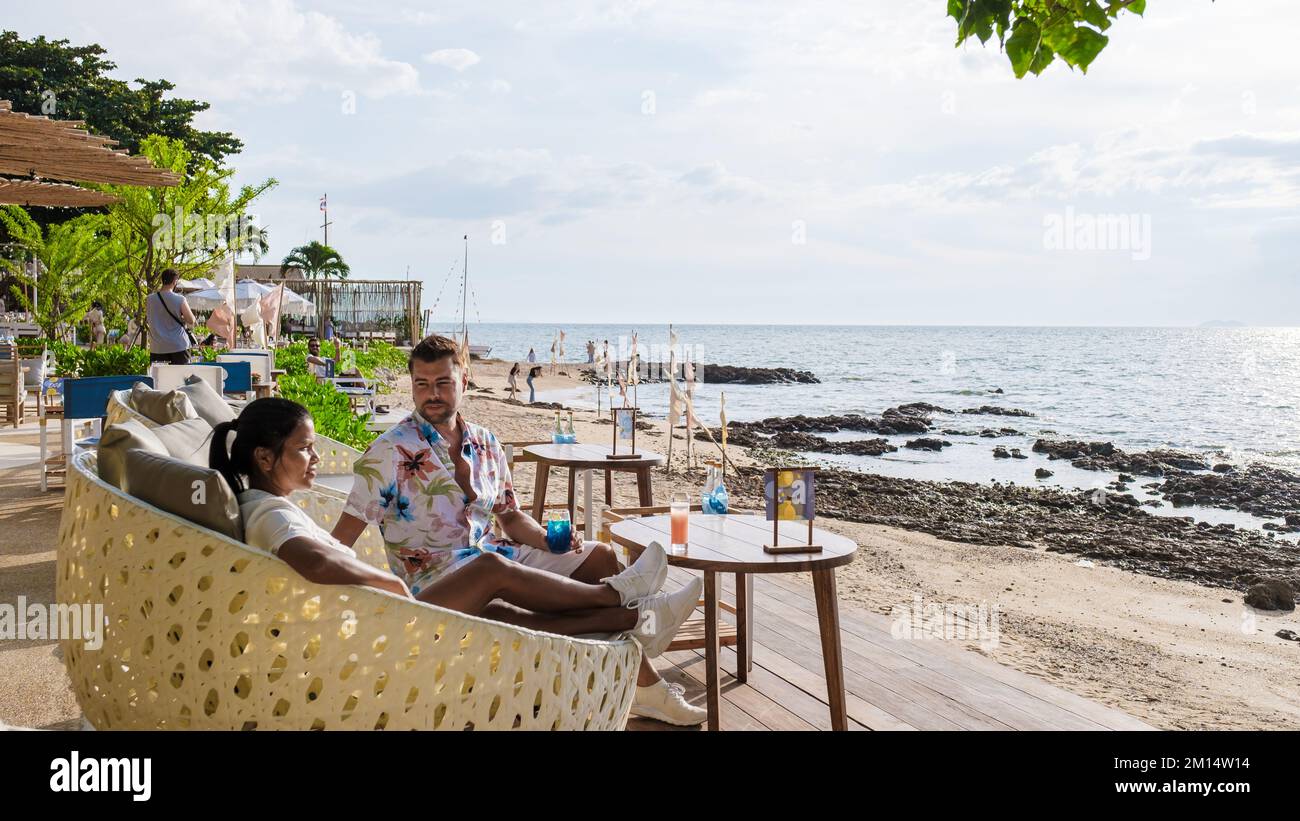 couple having lunch at a restaurant looking out over the ocean of ...