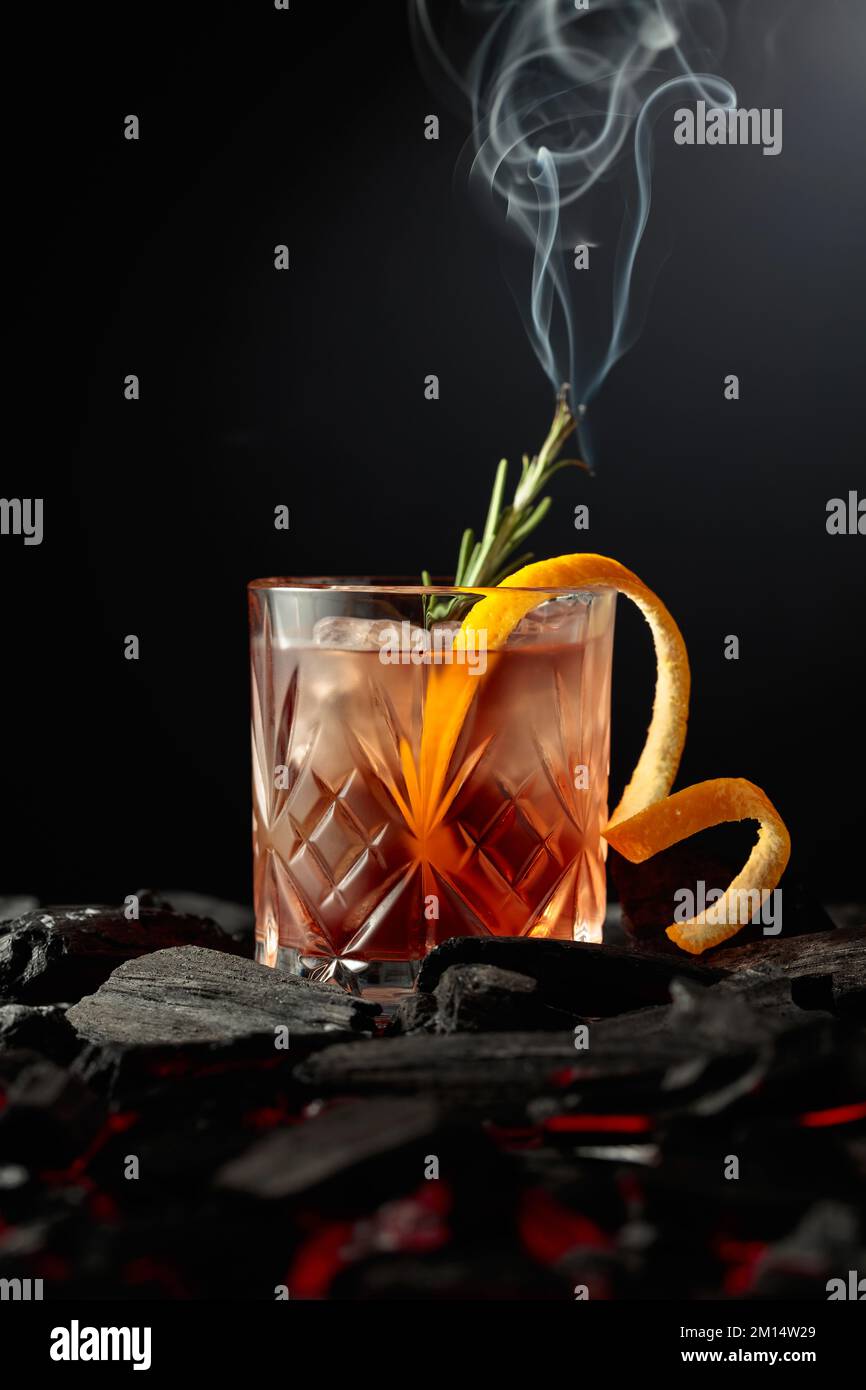 Old-fashioned cocktail with ice, orange peel, and rosemary. Whiskey ...