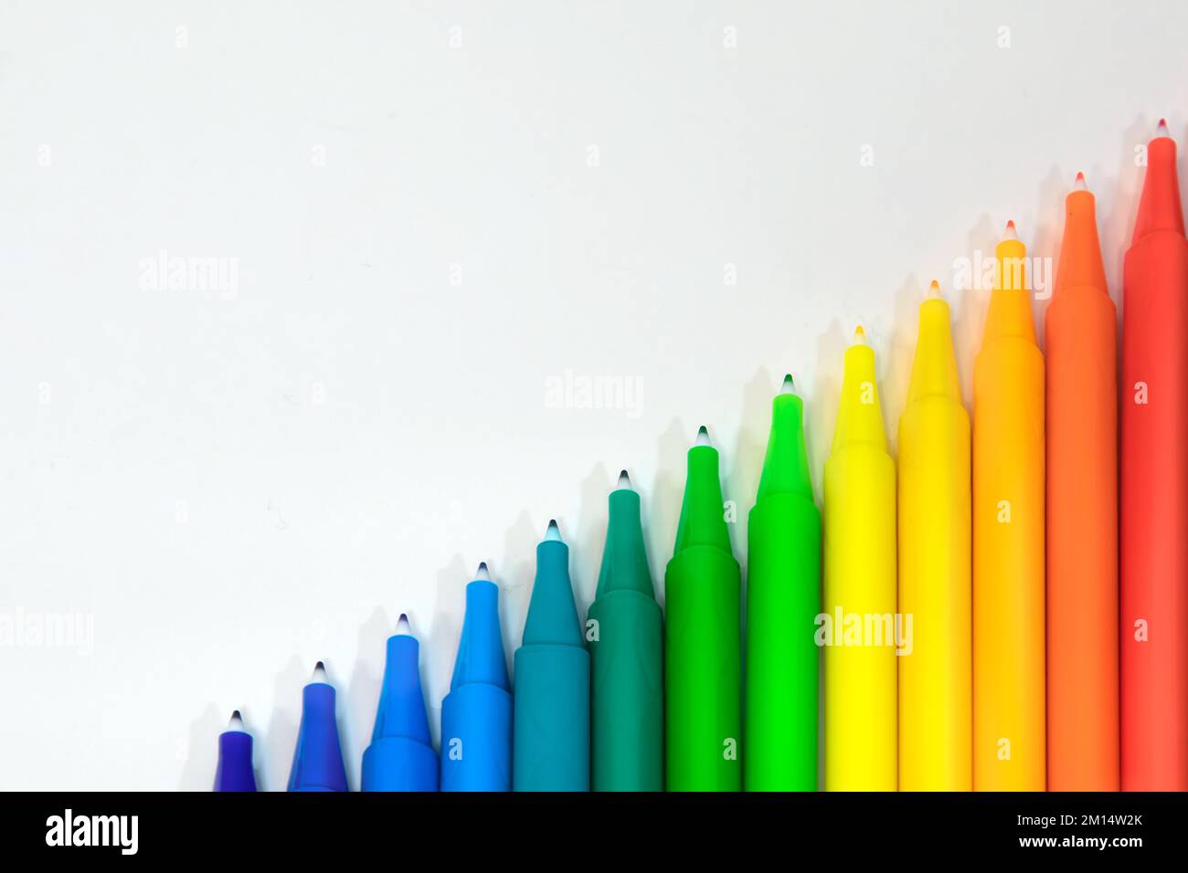 Colorful pens stacked sequentially on a white surface. Great for ...