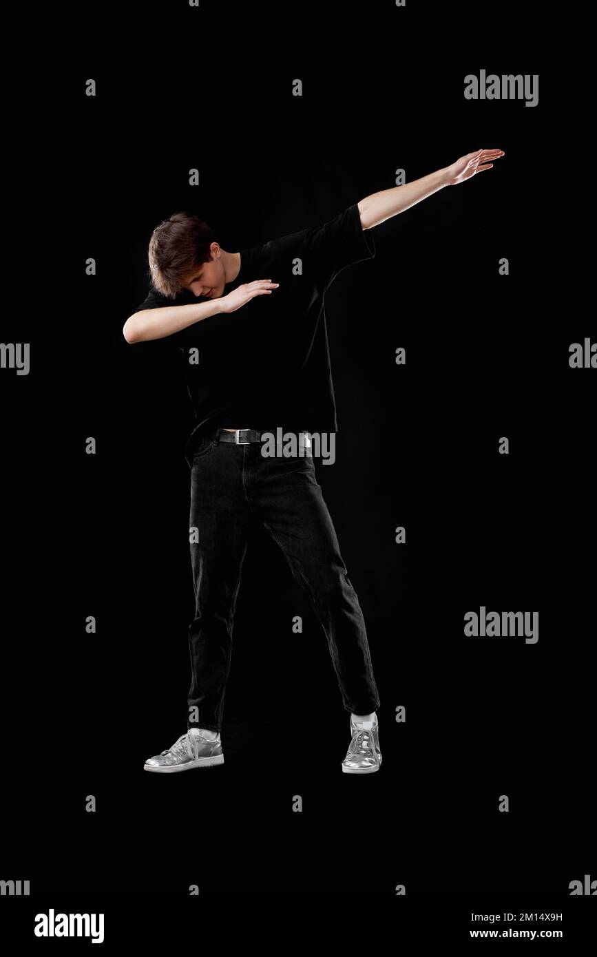 young man in black t-shirt and jeans dancing Stock Photo - Alamy