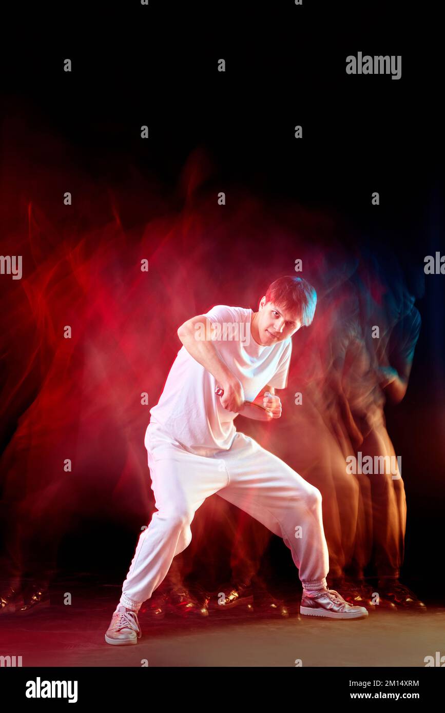 young man playing table tennis in mixed neon light Stock Photo - Alamy