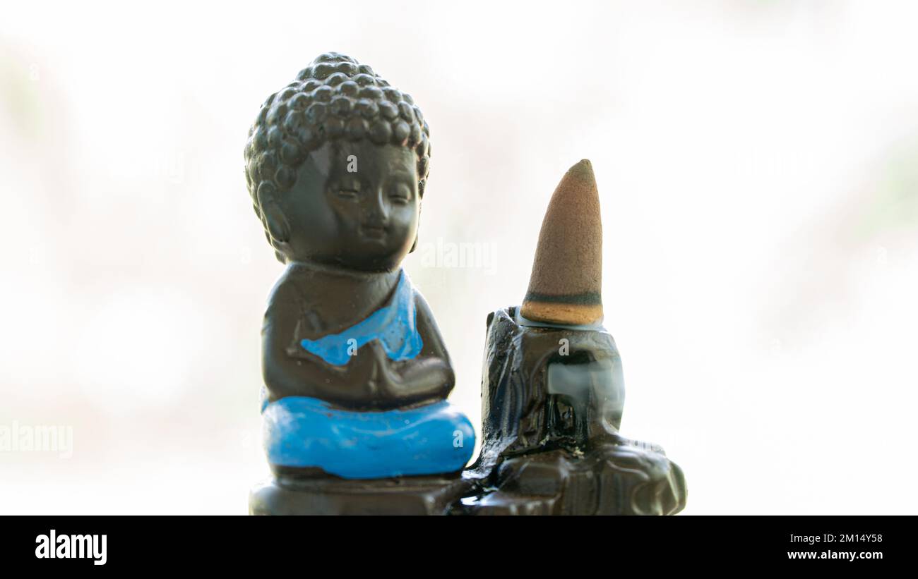 statuette of meditating buddha with incense cone, aromatherapy ...