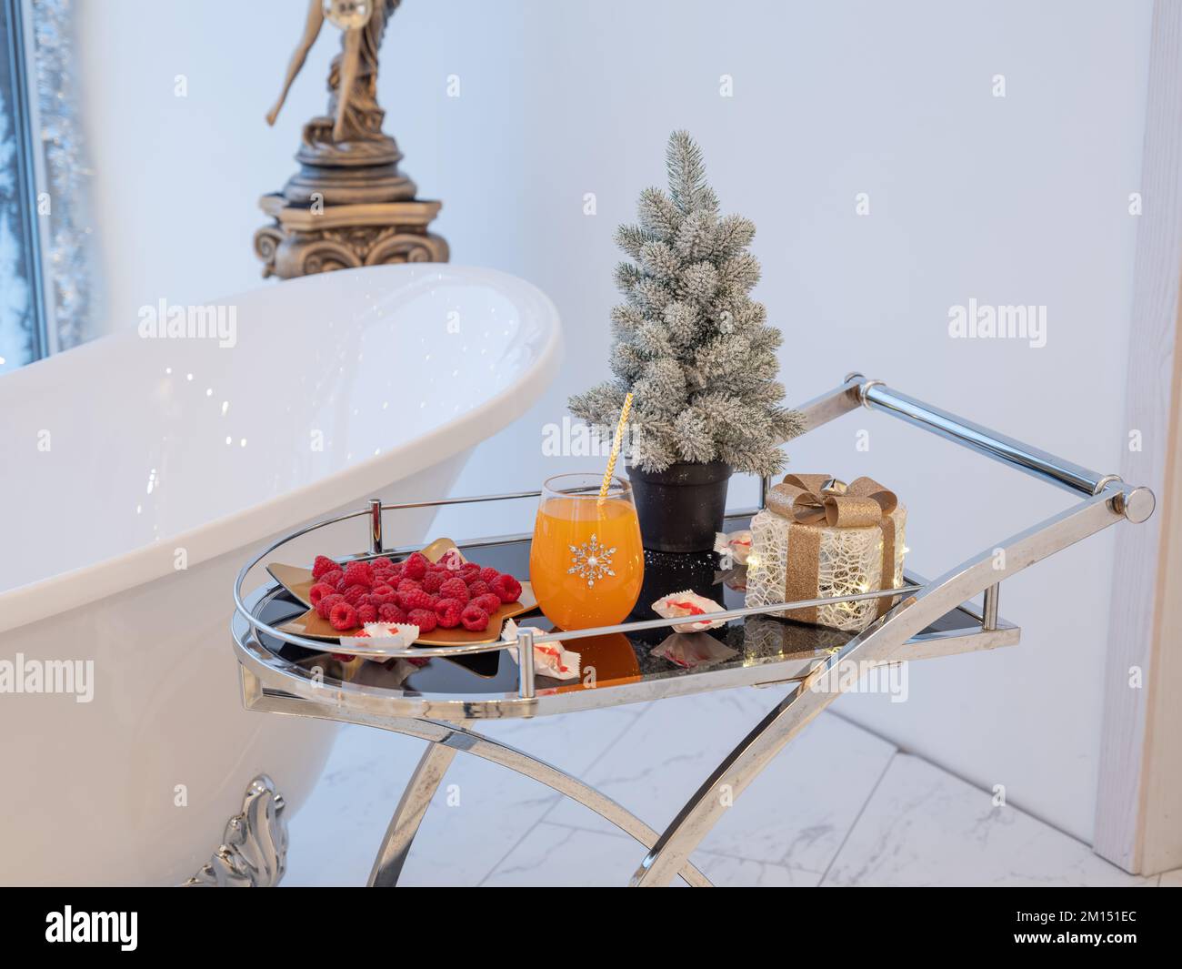 Raspberry, orange juice, wrapped gift. Christmas tree Stock Photo - Alamy