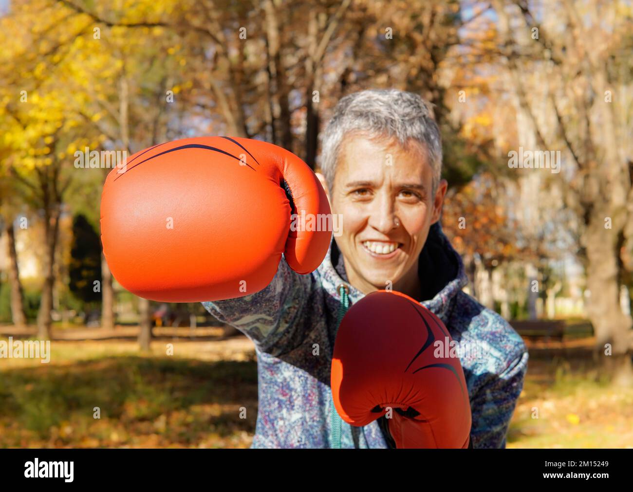gay female boxer boxing with red boxing globes. Sportswoman training ...