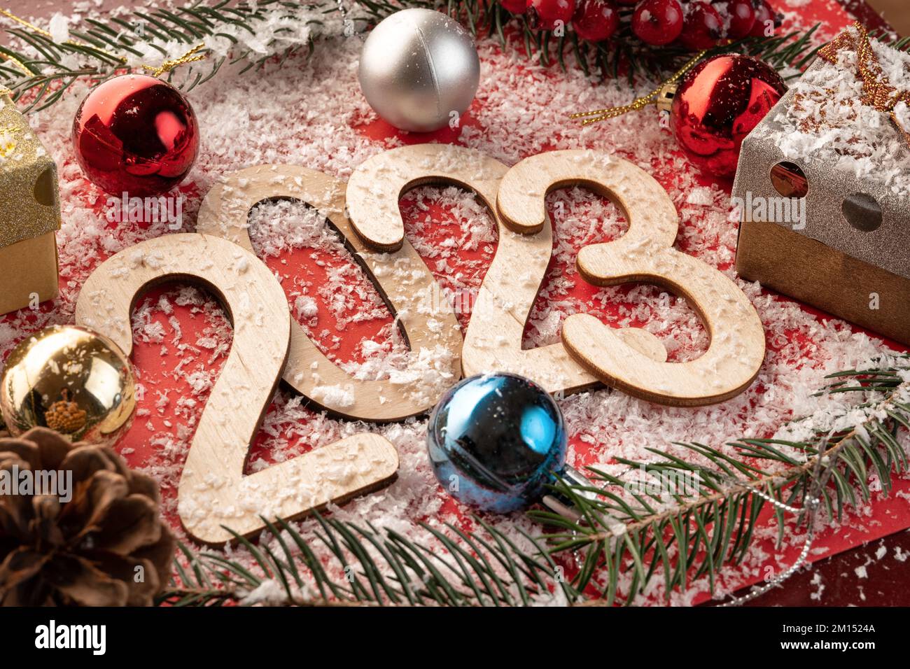 New Year's number 2023 made of wooden numbers on red paper with ...