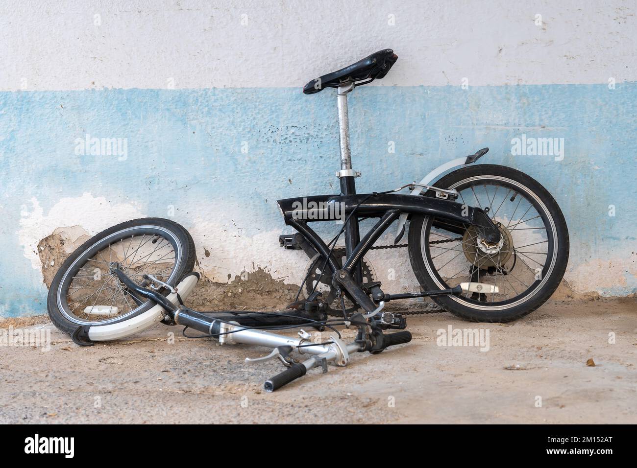 Bicycle with a frame broken in half stands against the wall Stock Photo ...