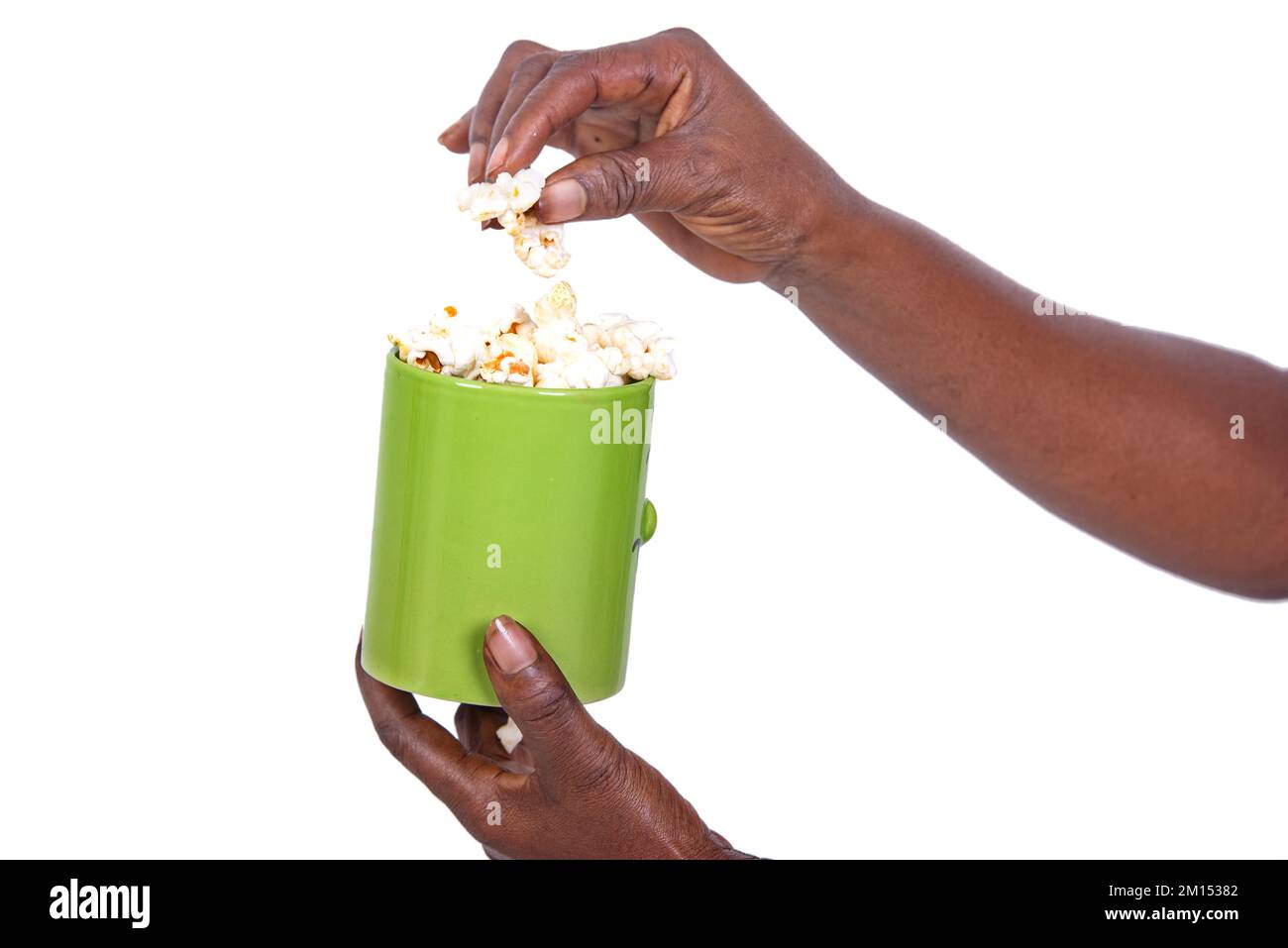 portrait of a female hand taking popcorn from a cup. isolated on white ...