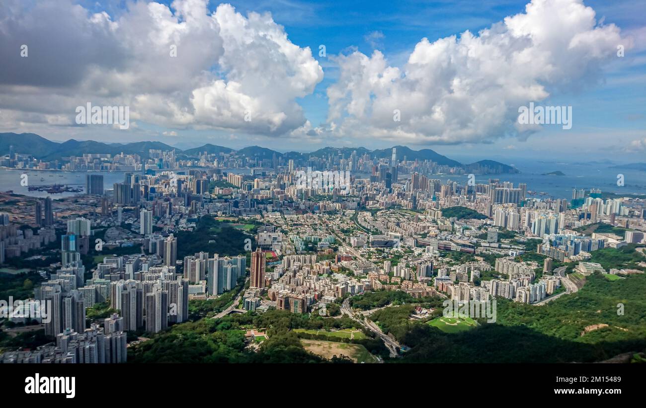 A cityscape of Kowloon surrounded by mountains and greenery in Hong ...