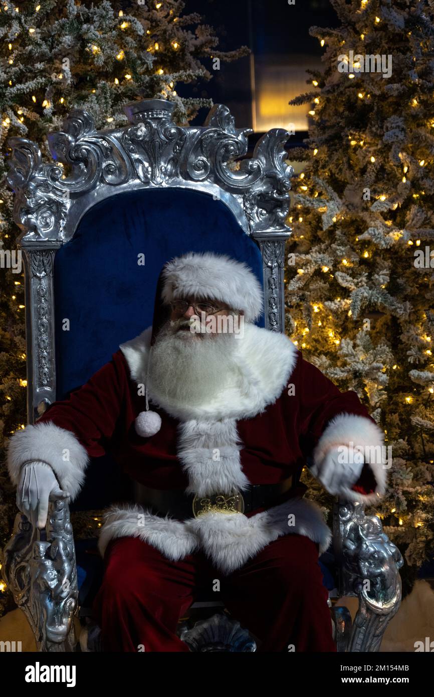 A traditional American Santa Claus waiting for a child to sit on his ...