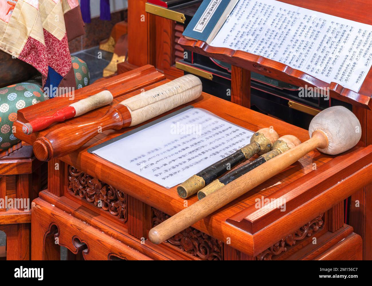 Prayer room of a Japanese temple with sutra booklets on a wooden table ...