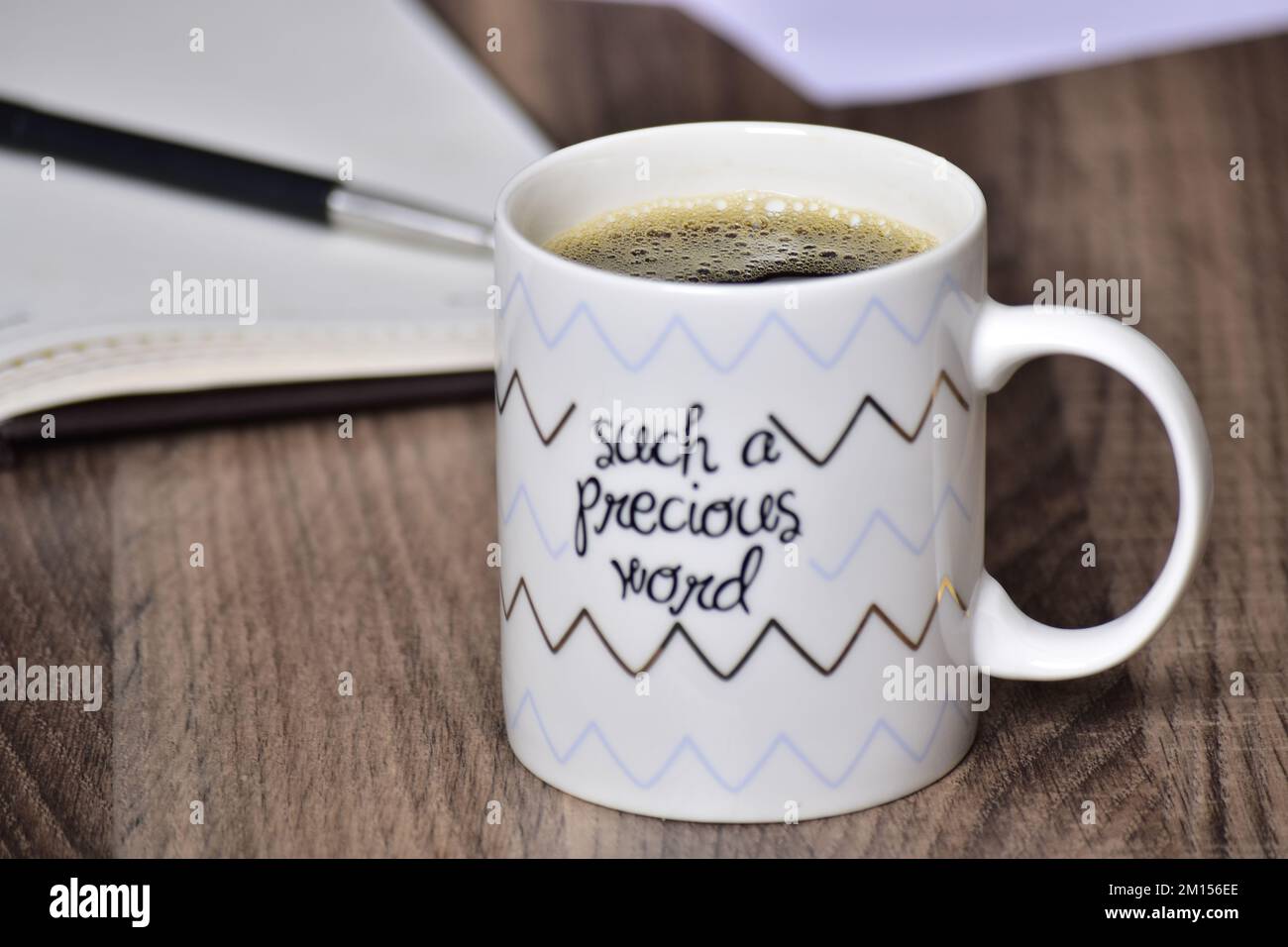"Such a precious word" quote on black coffee mug on table Stock Photo ...