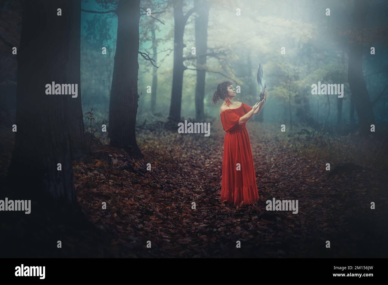 Shaman woman in deep mystical misty forest, with feathers fan with deer ...